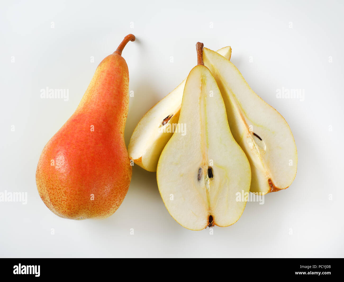 whole and sliced yellow pears on white background Stock Photo - Alamy
