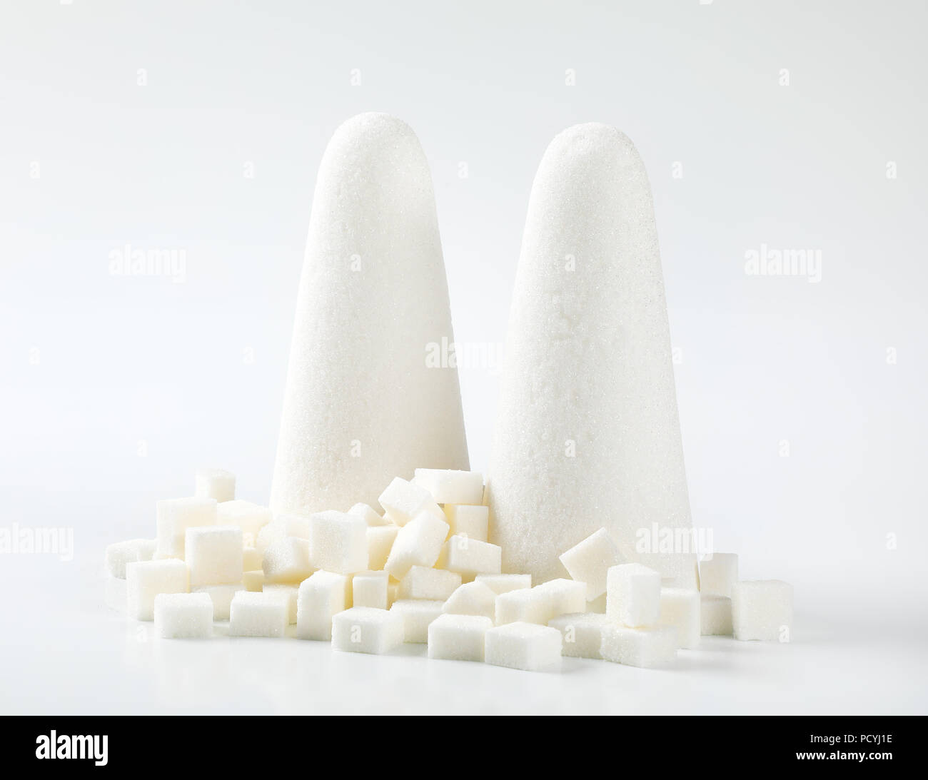 white sugar loaves and cubes on white background Stock Photo - Alamy