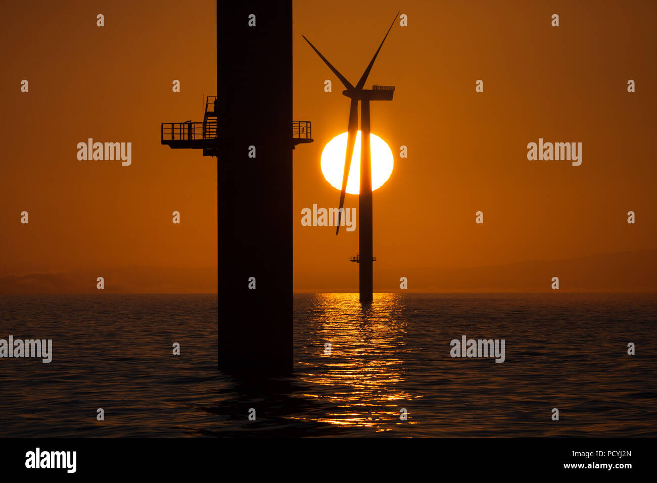 Sunrise over offshore wind turbines on Walney Offshore Wind Farm in the ...