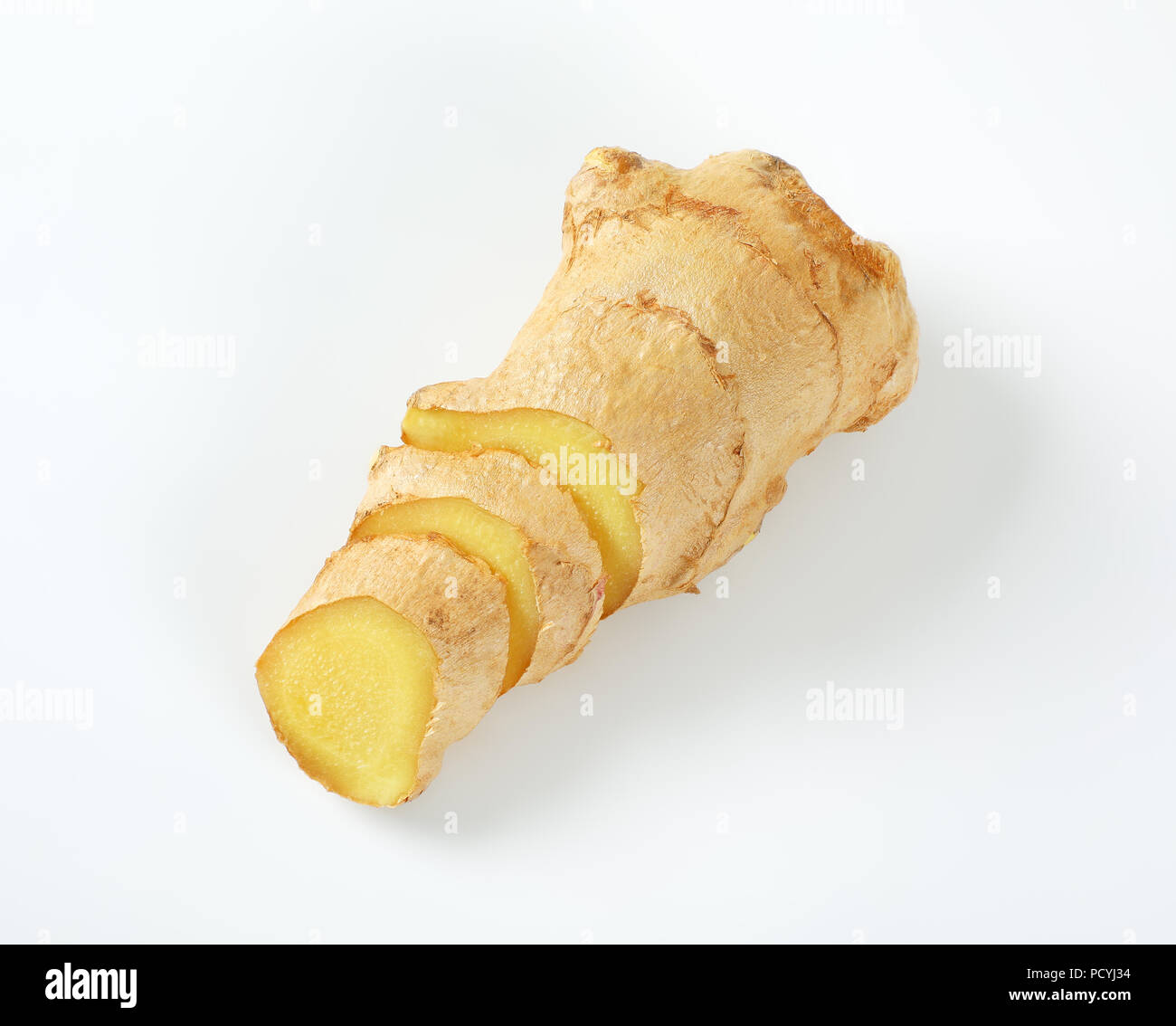 sliced ginger root on white background Stock Photo - Alamy