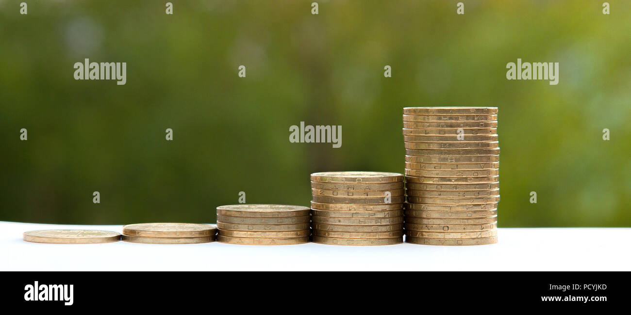 Histogram of coins and bamknotes on a green background. Concept of ...