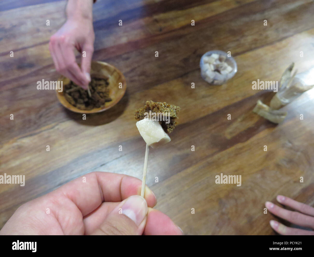 Tooth pick with a piece of fermented shark meat and bread in the shark ...