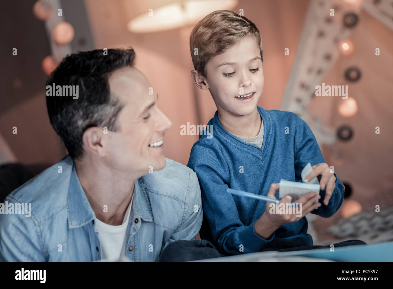 Happy kid looking at stickers Stock Photo - Alamy