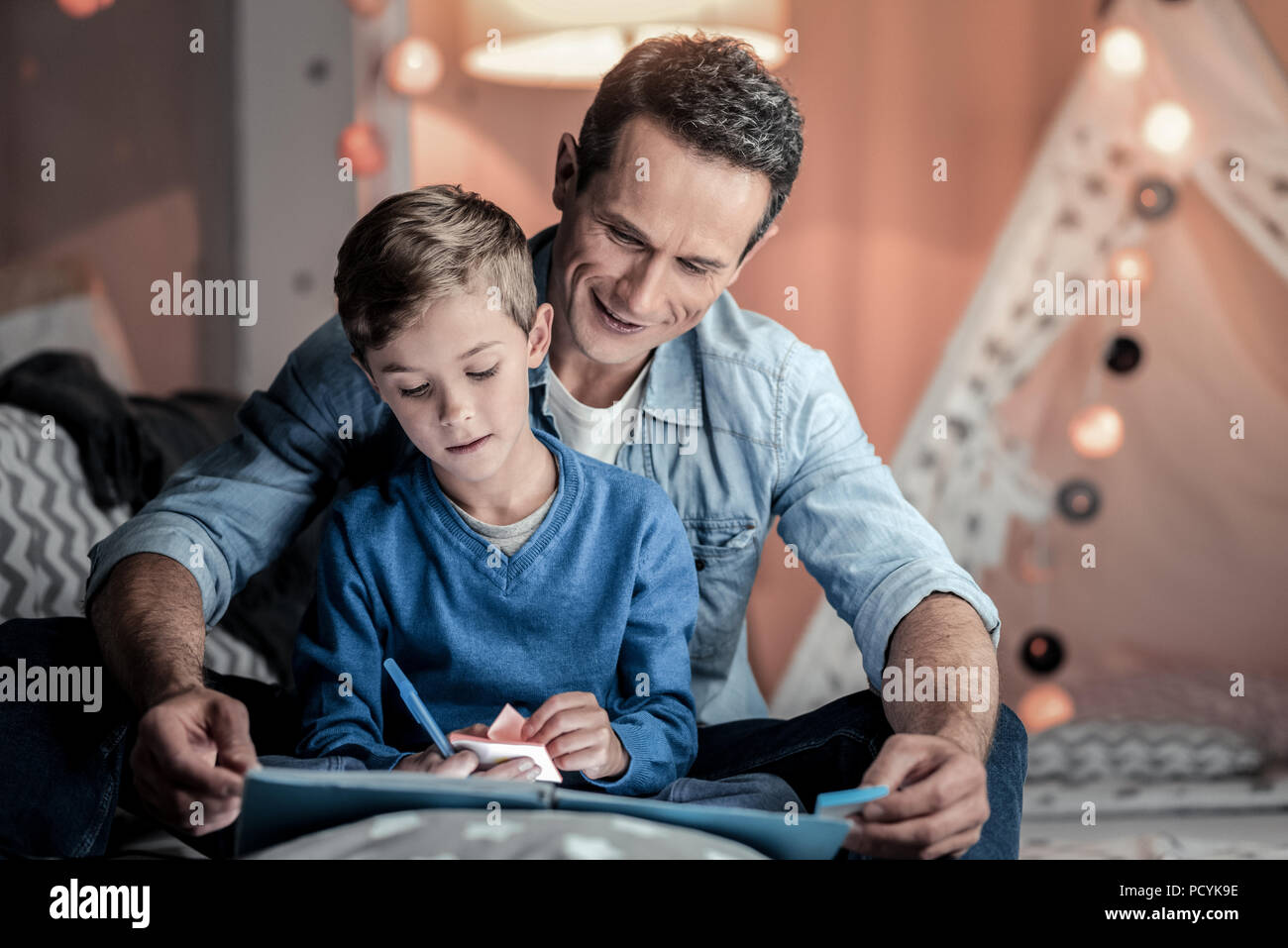 Concentrated boy doing his home task Stock Photo - Alamy