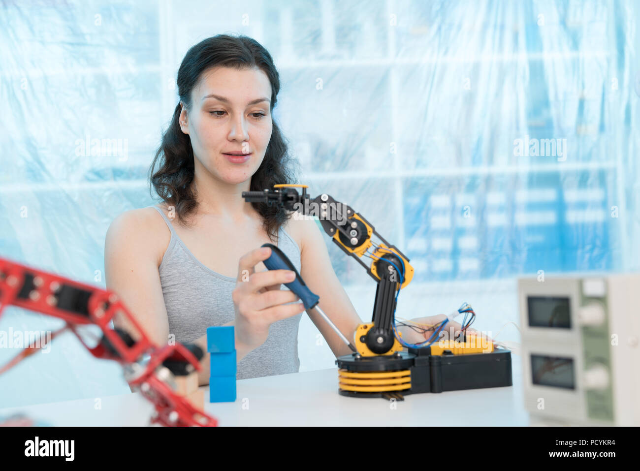 girl in a University laboratory is experimenting with a robot Stock ...