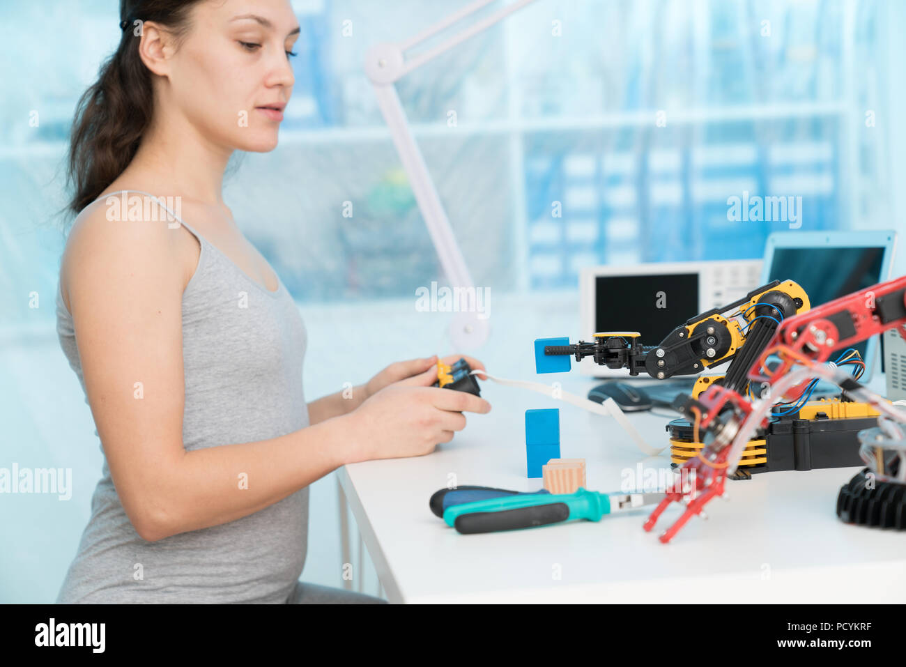 girl in a University laboratory is experimenting with a robot Stock ...