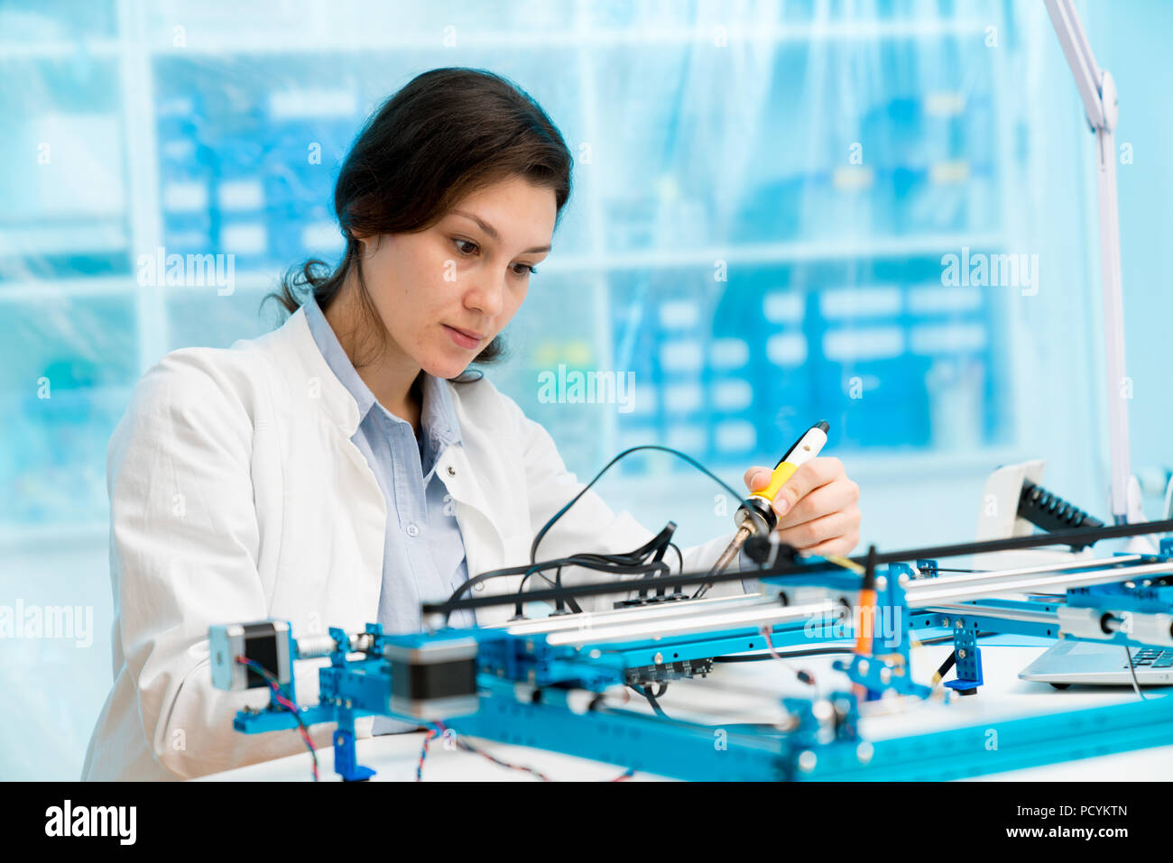 Student girl in electronics laboratory, experiment with microcontroller ...