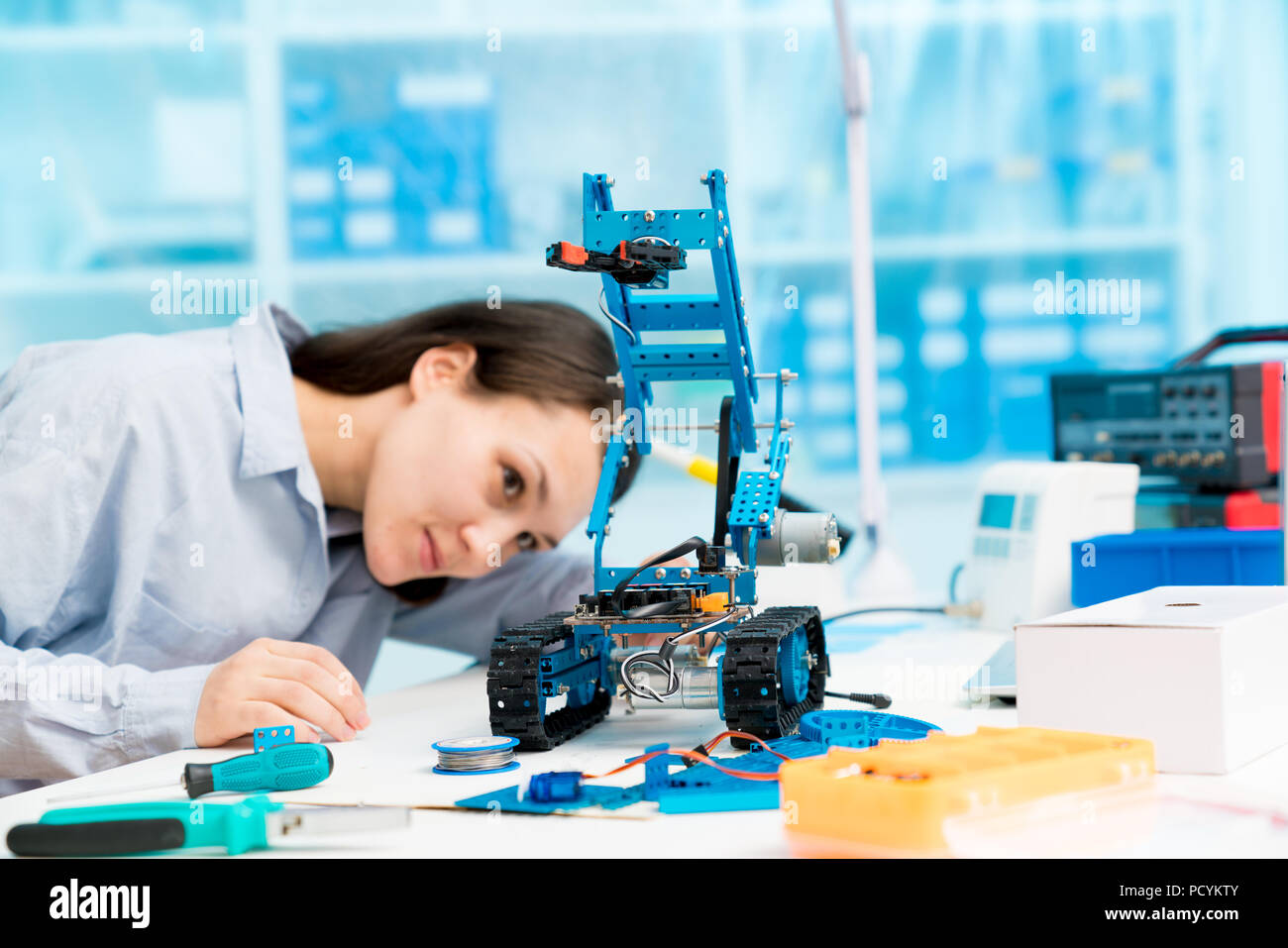 Student girl in electronics laboratory, experiment with microcontroller ...