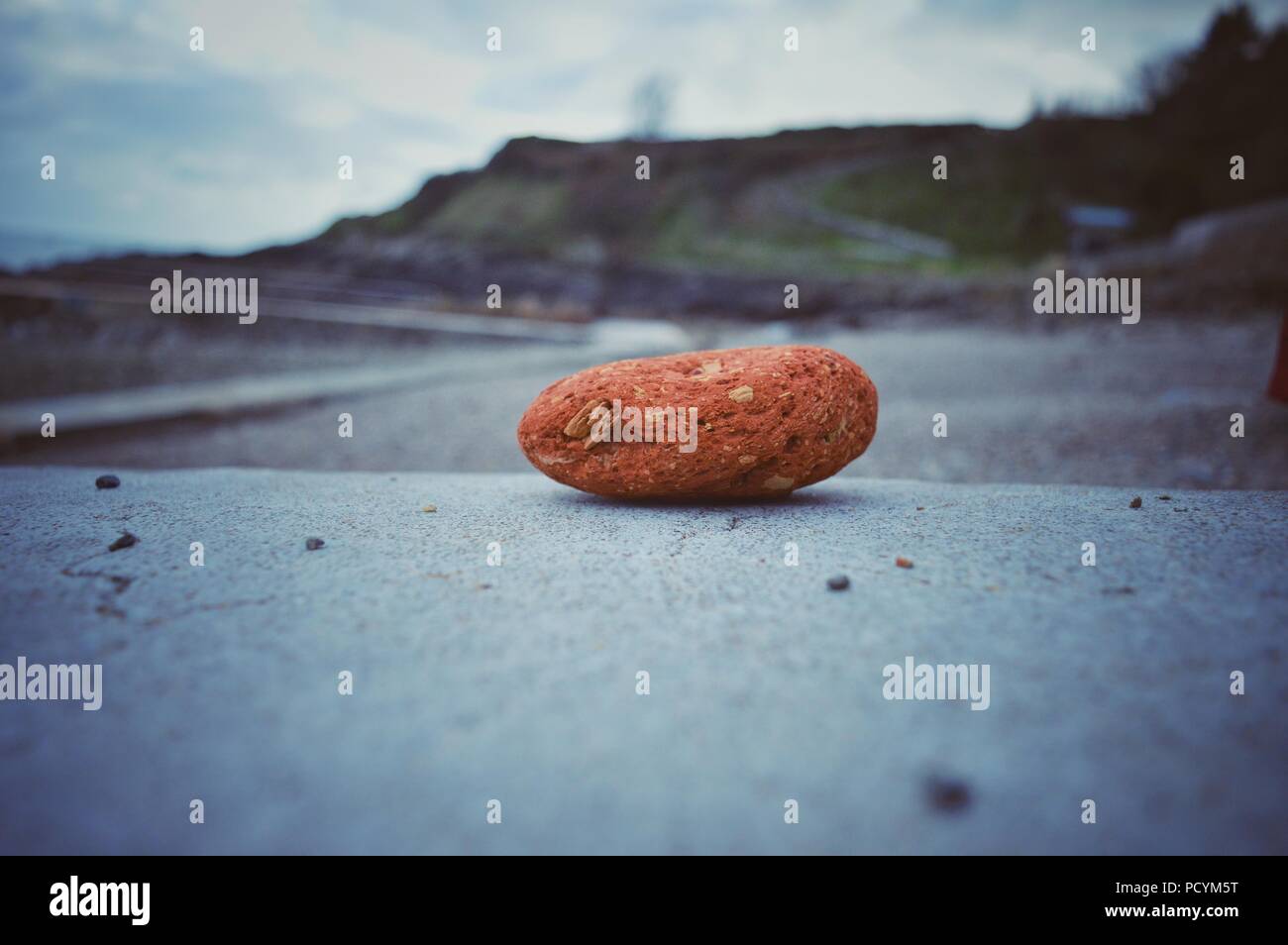 A photo of a still rock with the hills behind Stock Photo - Alamy