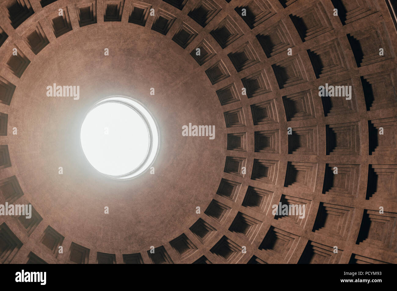 Sunlight shining in through a skylight in a dome of a building viewed ...