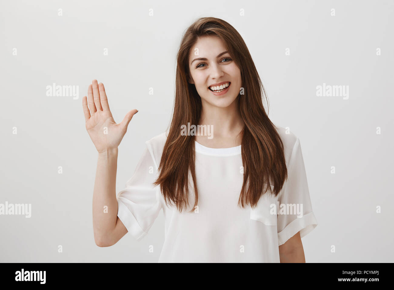 Friendly woman says hi to new neighbours. Portrait of charming young ...