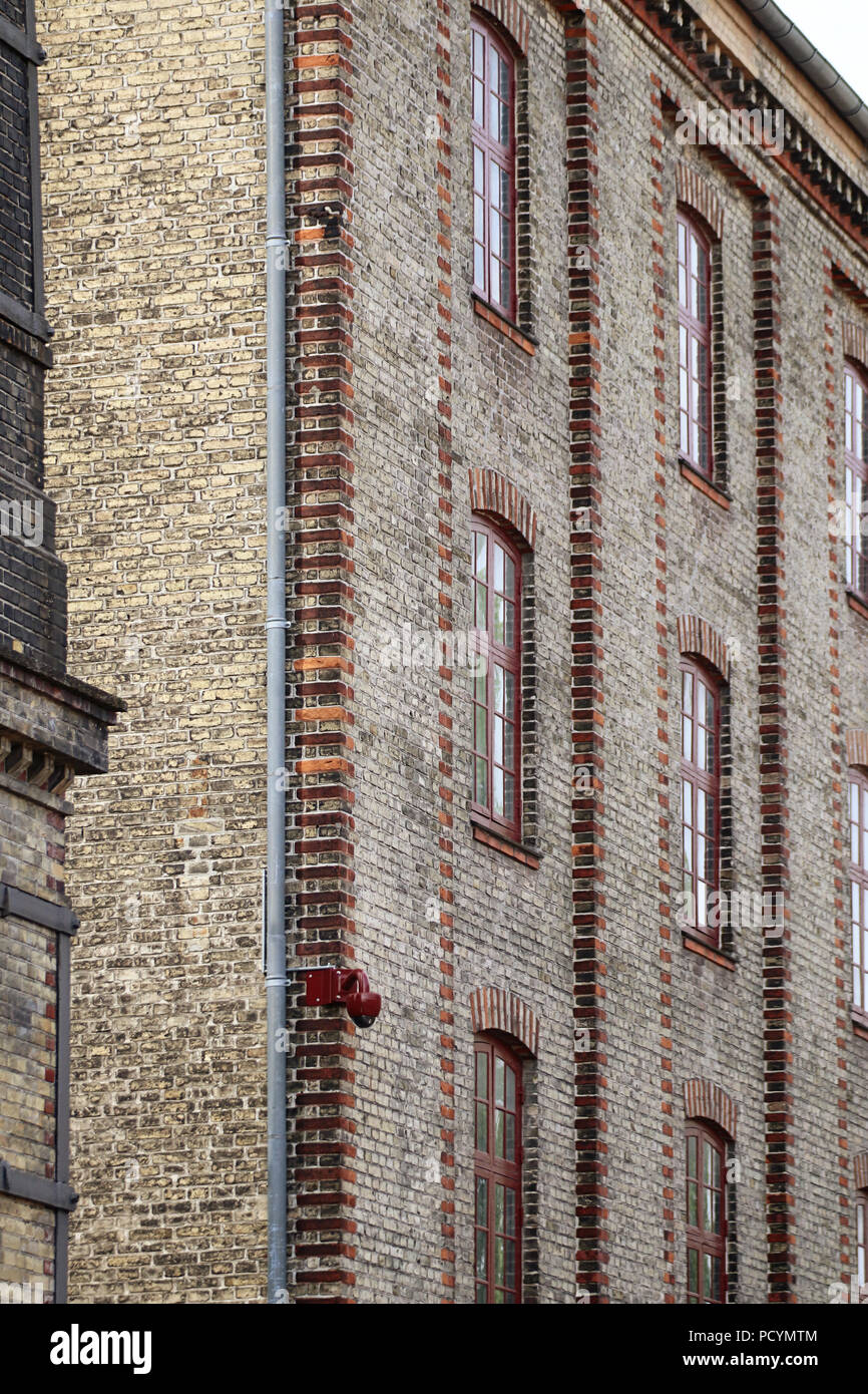 Brick, stone and mortar facade of antique industrial building with ...