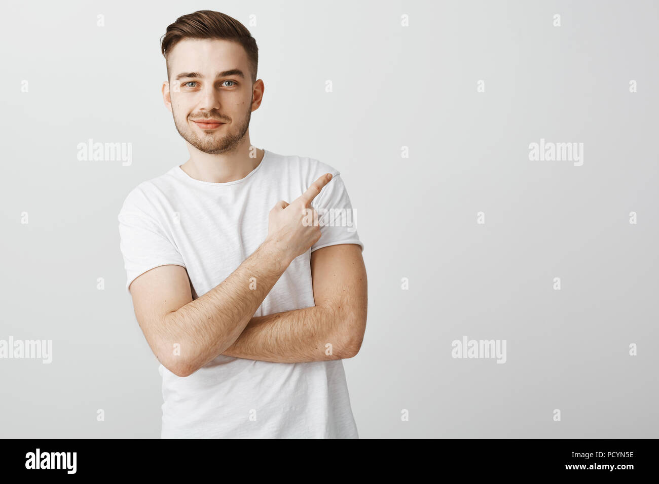 Studio shot of satisfied relaxed and handsome unshaven mature male with ...