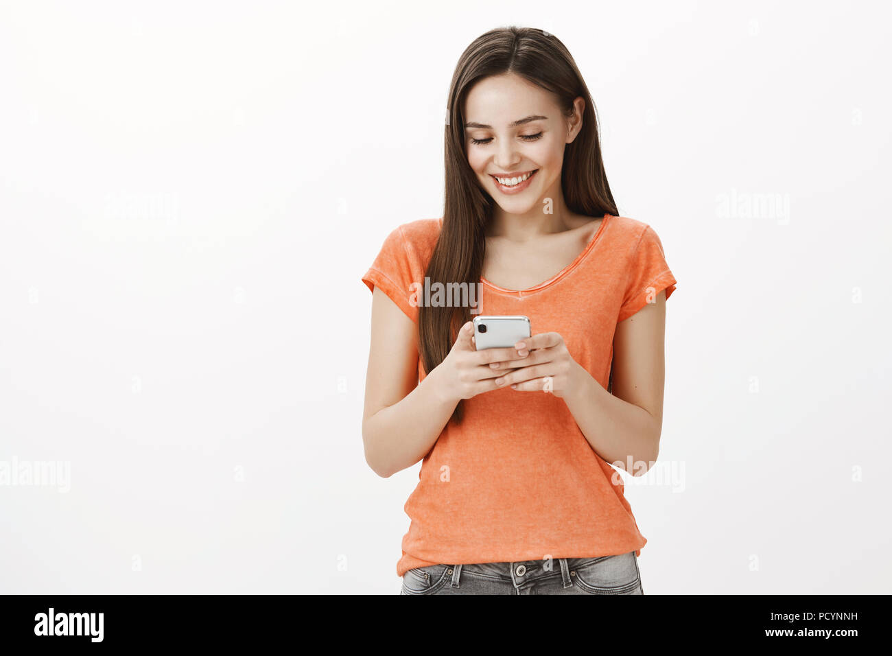 Perfect message from boyfriend. Studio shot of satisfied beautiful dark ...