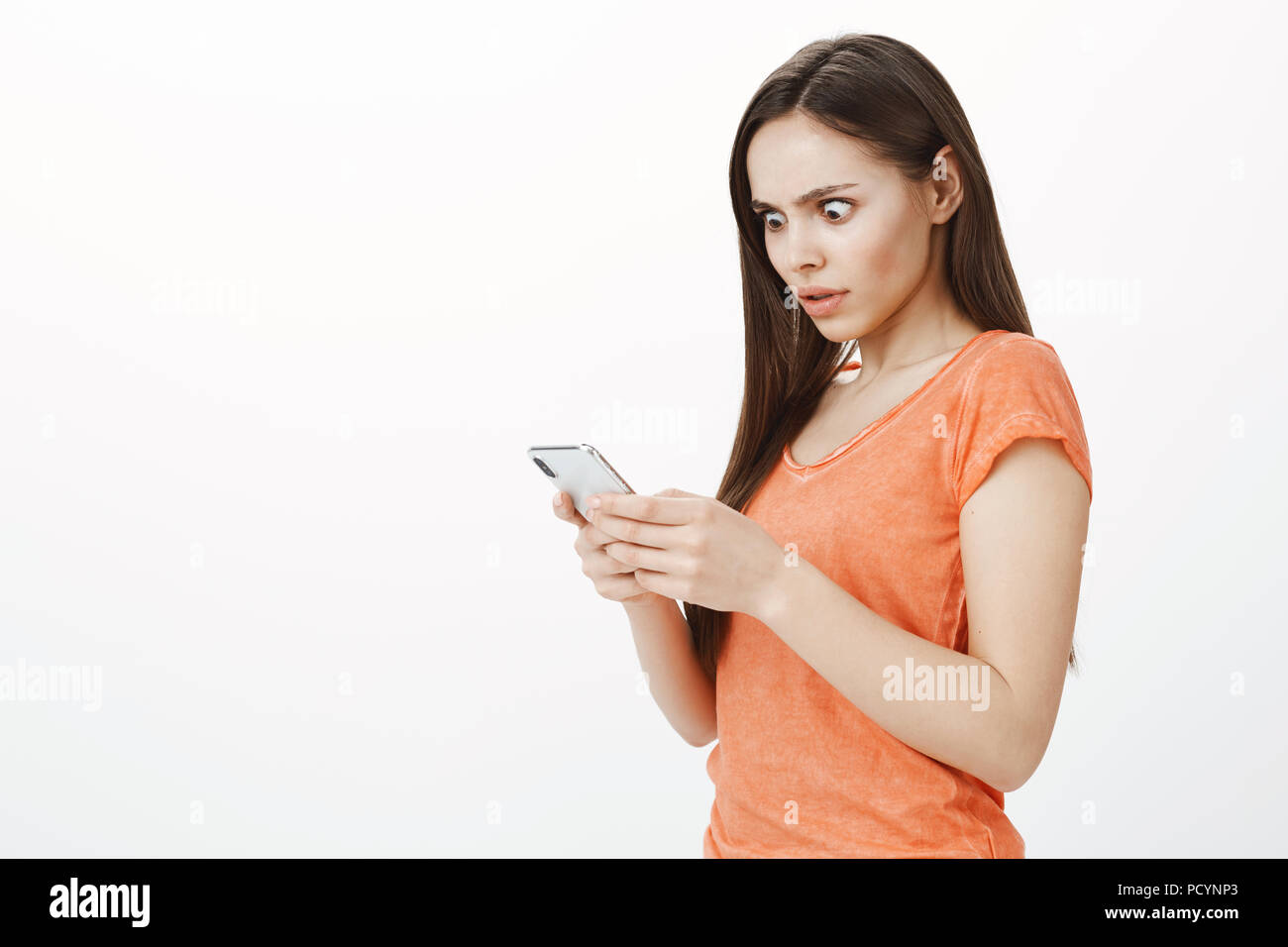 Studio profile portrait of shocked and confused funny woman in casual ...