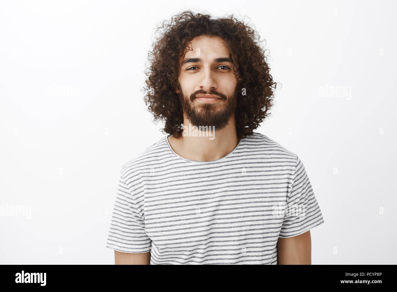 Portrait of handsome confident creative boyfriend with dark curly hair ...