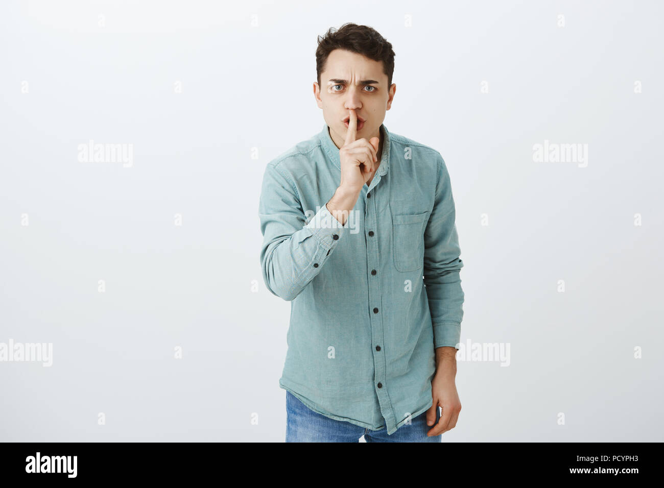 I order you keep voice down. Portrait of displeased serious young man ...