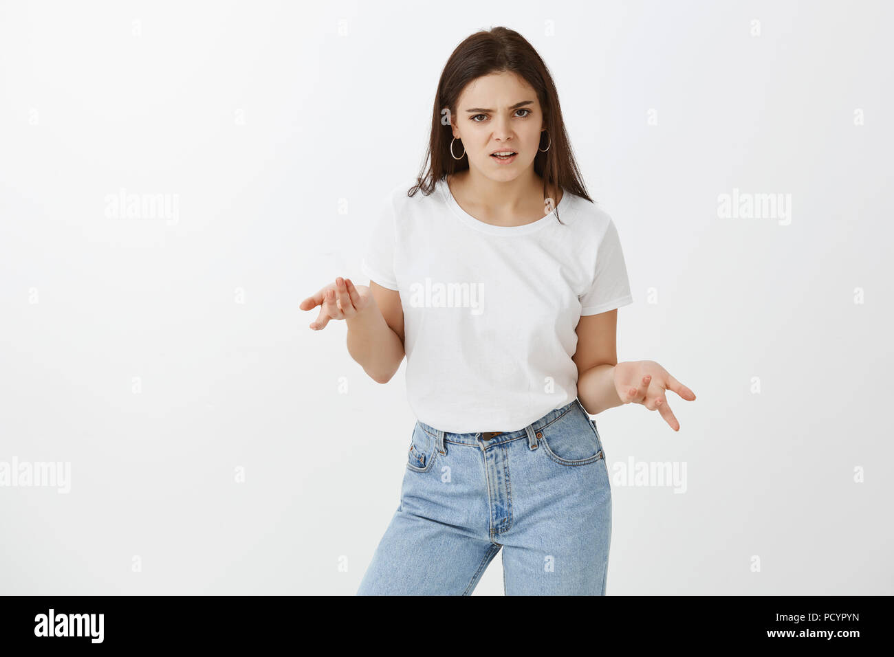 Studio shot of irritated arrogant good-looking urban female in t-shirt ...