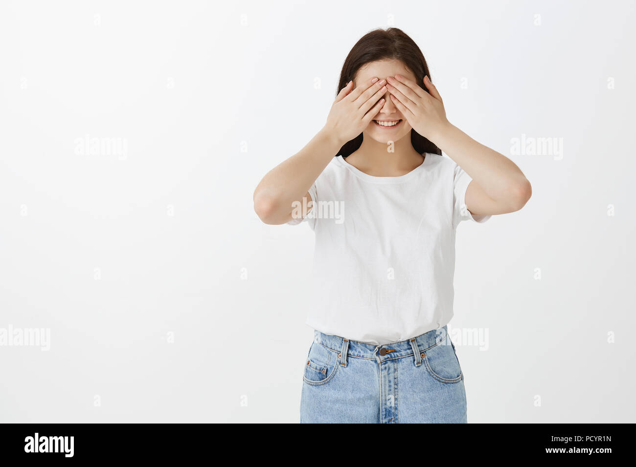 Tell me when I can open eyes. Portrait of charming joyful caucasian ...