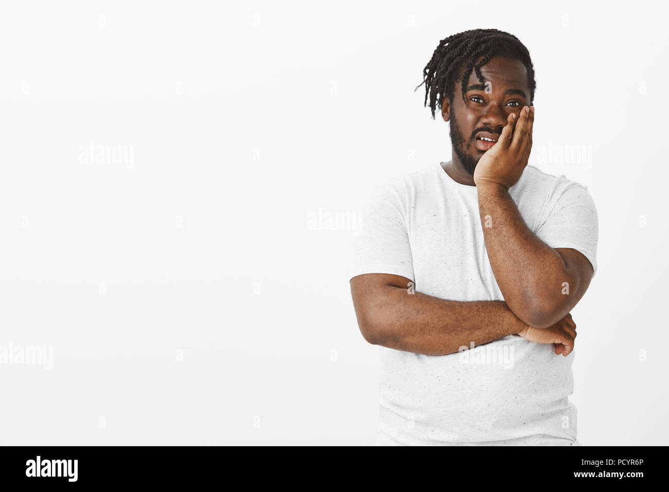 Portrait of unimpressed shocked young african male in white t-shirt ...