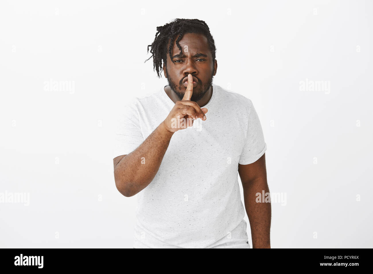 Keep voice down, it is order. Serious displeased funny plump guy with ...