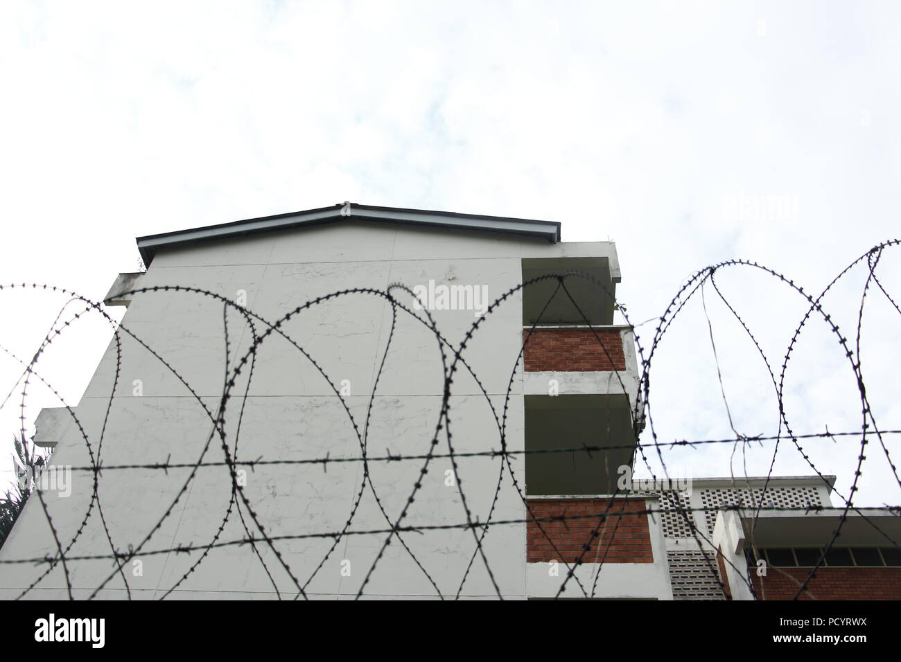 Barbed wires in front of army camp Stock Photo - Alamy