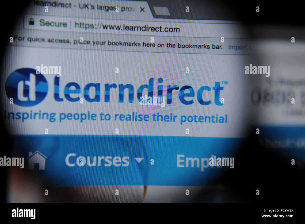 The Learndirect website seen through a magnifying glass Stock Photo - Alamy