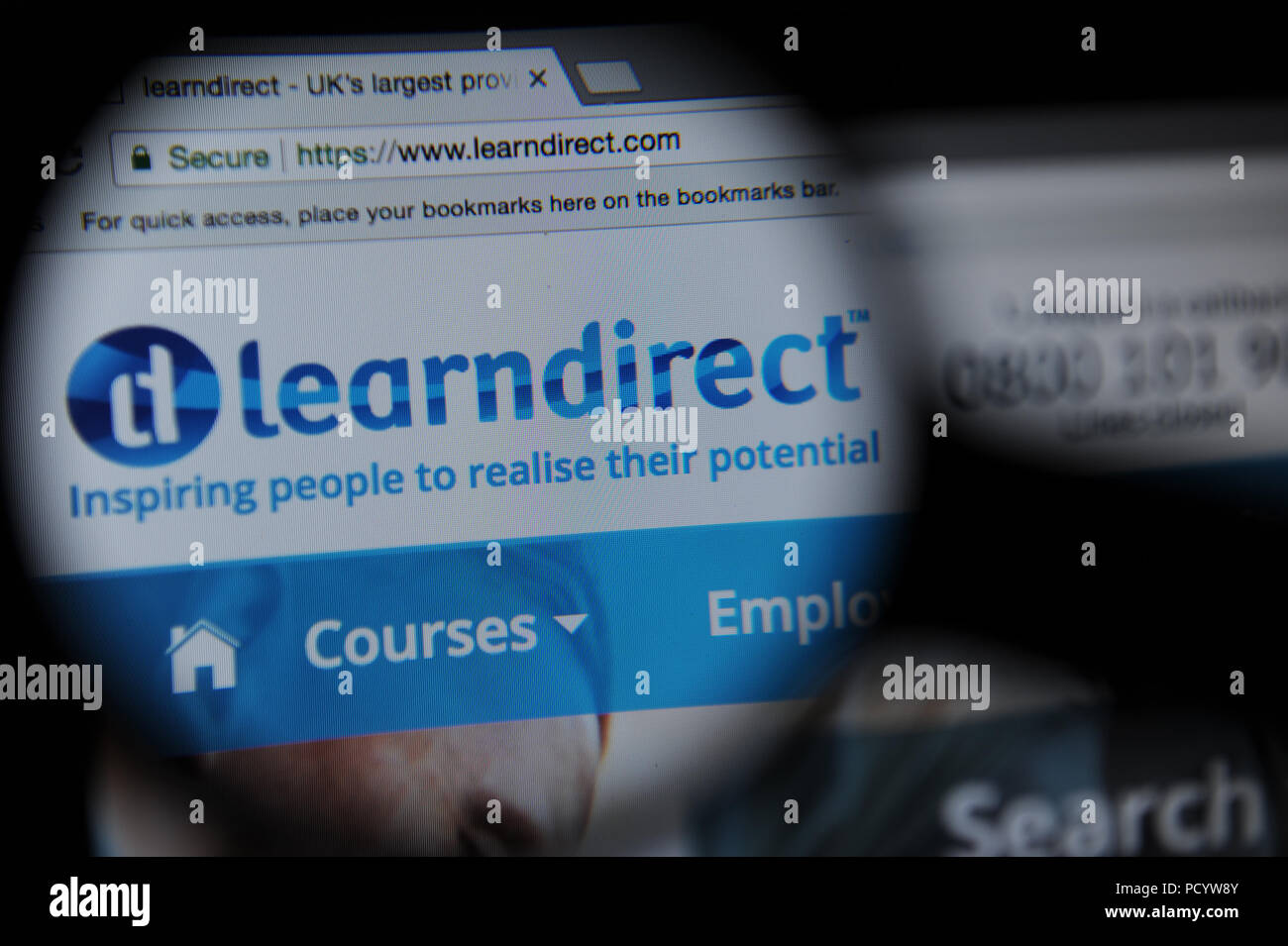 The Learndirect website seen through a magnifying glass Stock Photo - Alamy