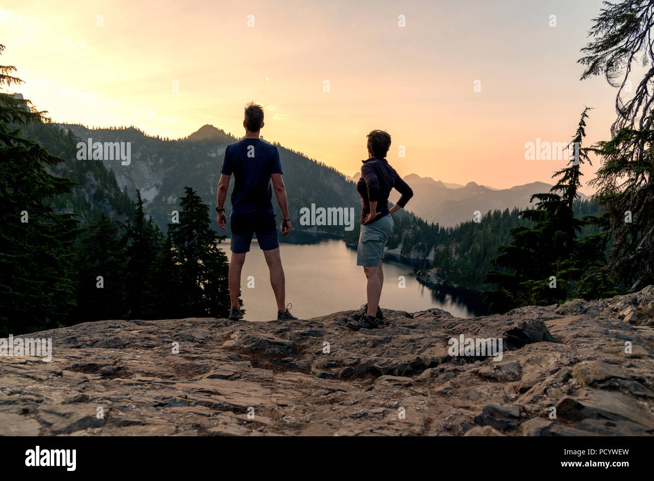 Standing couple hikers overlooking hi-res stock photography and images ...