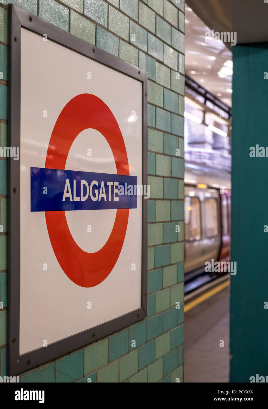 Platform at Aldgate Underground Station, London showing station name in ...