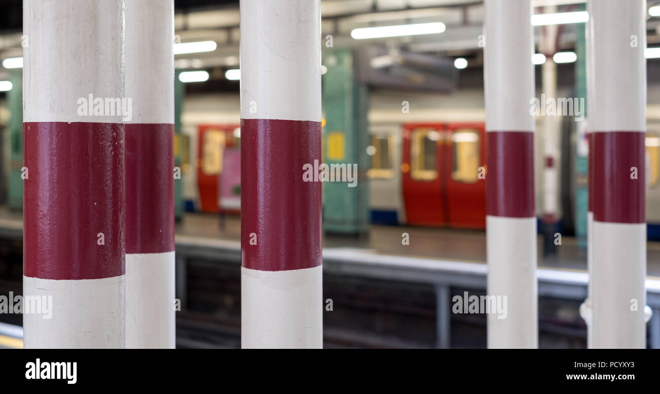 Platform at Aldgate Underground Station, London showing painted pillars ...