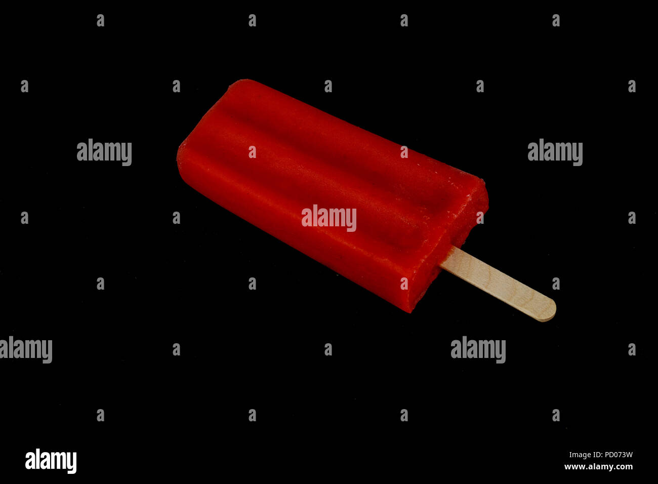 Raspberry red ice cream balls in ice cream spoon with mint over black ...