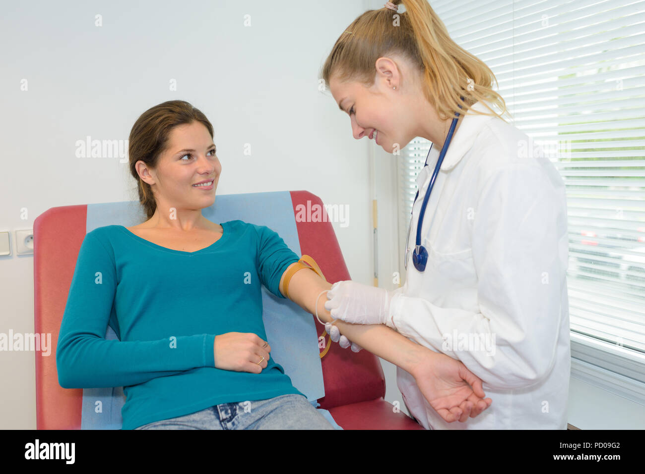 doctor doing a blood test on female patient Stock Photo - Alamy