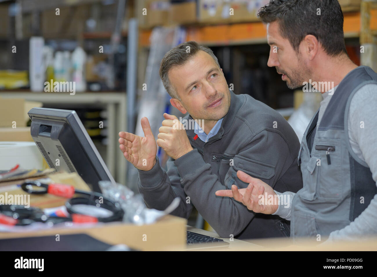 two workers workers in warehouse Stock Photo - Alamy