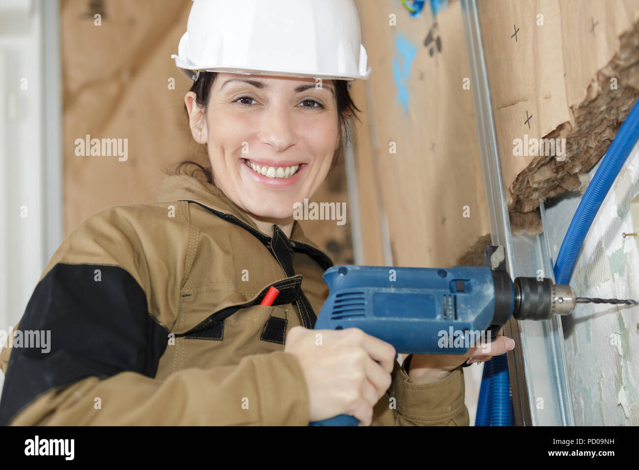 adult female woodworker with power drill drilling into wood board Stock ...