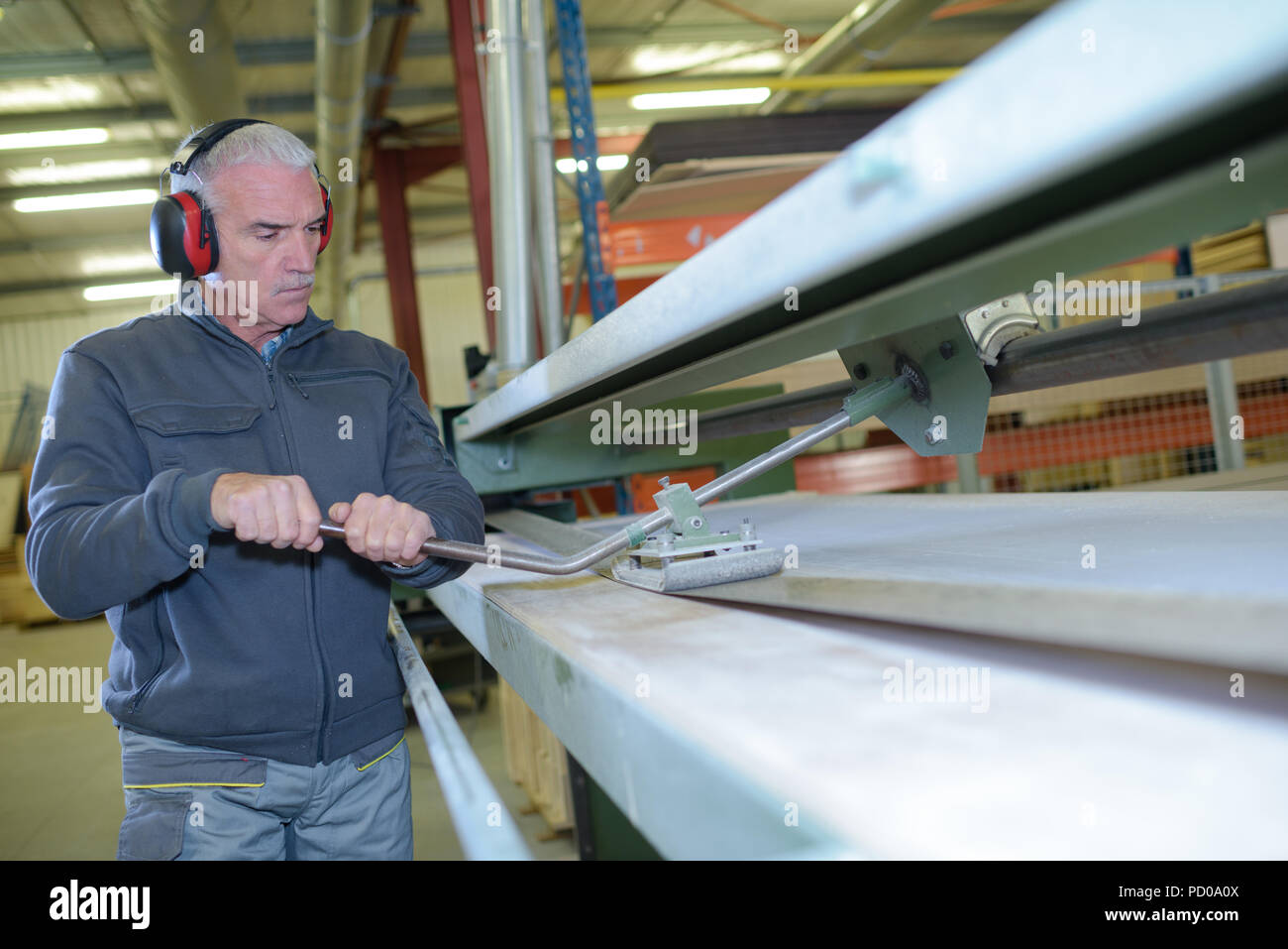 Worker setting up factory machine hi-res stock photography and images ...
