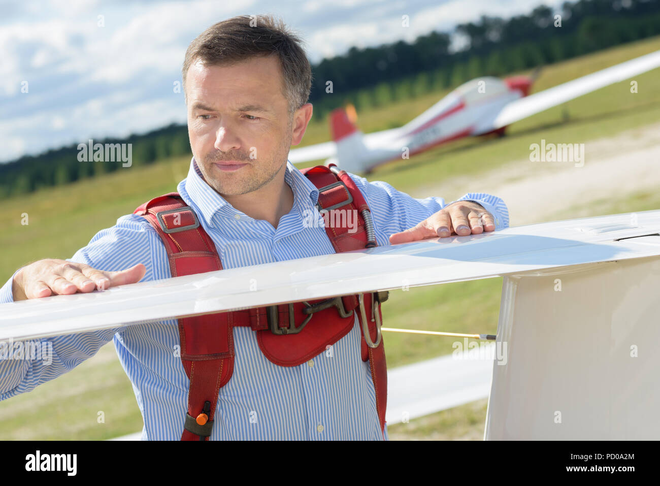 Man inspecting wing of glider Stock Photo - Alamy