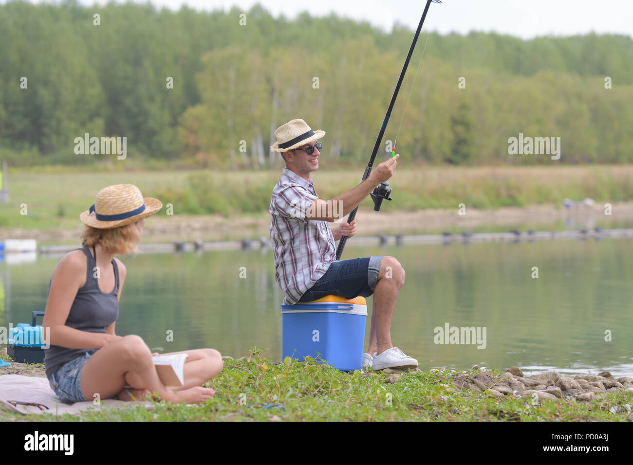 young couple fishing Stock Photo - Alamy