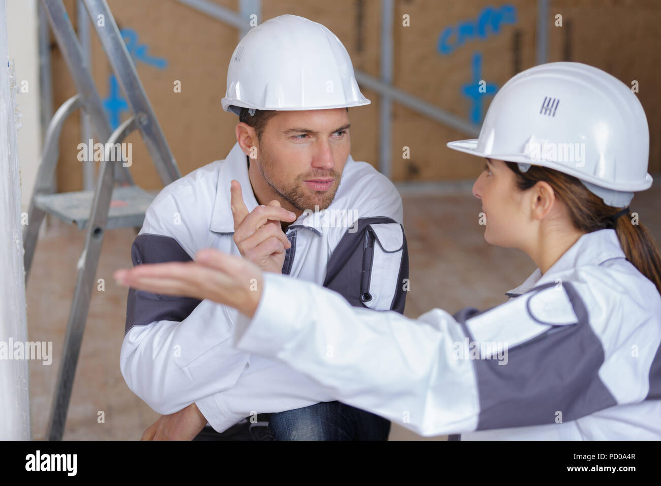 builders having a conversation Stock Photo - Alamy