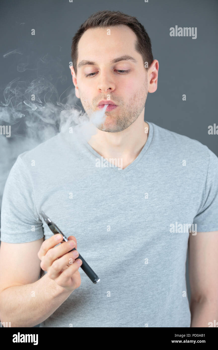 vaping man holding a mod Stock Photo - Alamy