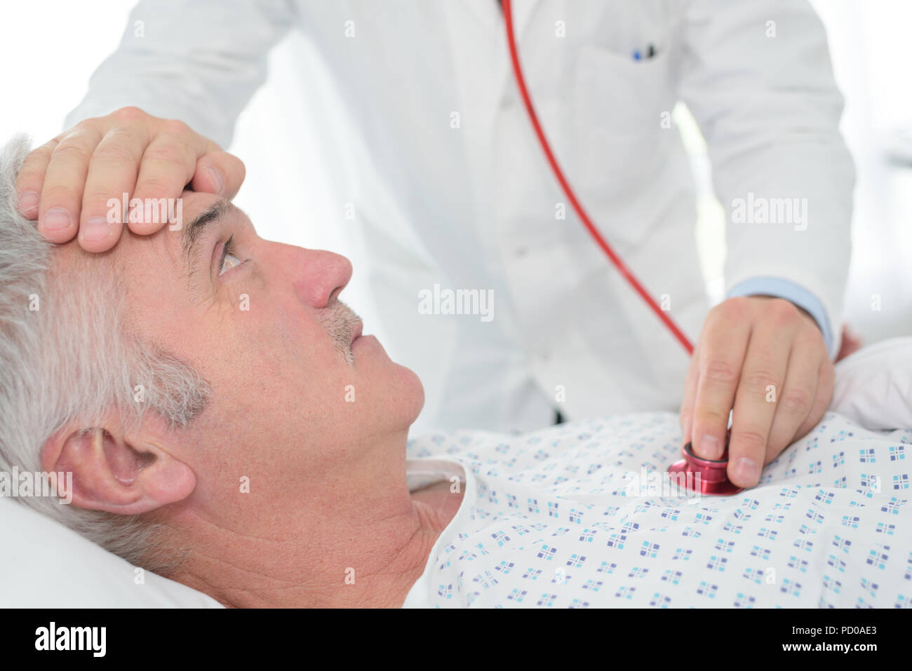doctor checking on senior patient heart rate Stock Photo - Alamy