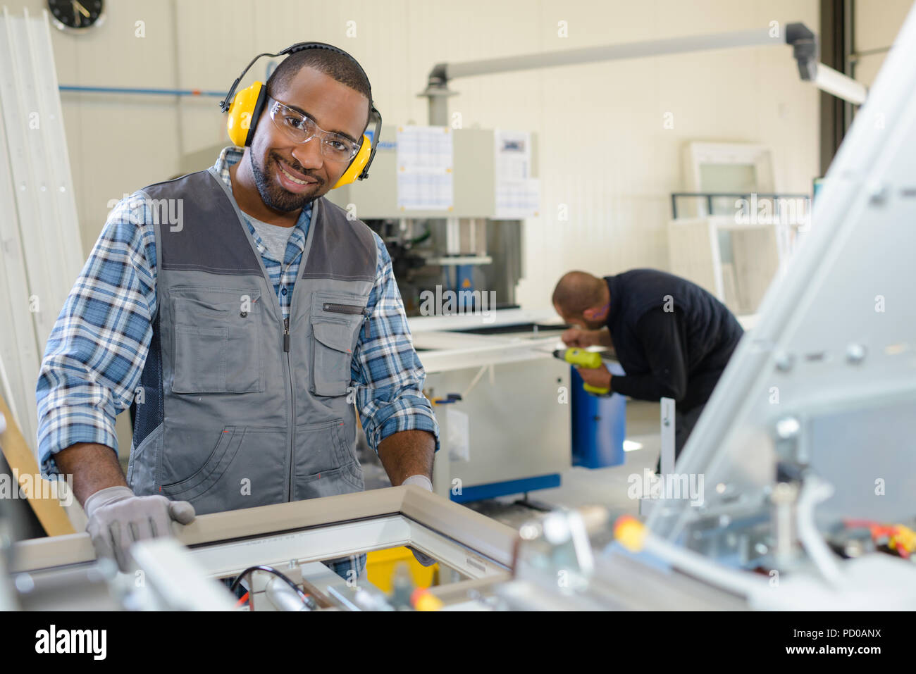 positive smiling worker on lathe machine at factory Stock Photo - Alamy