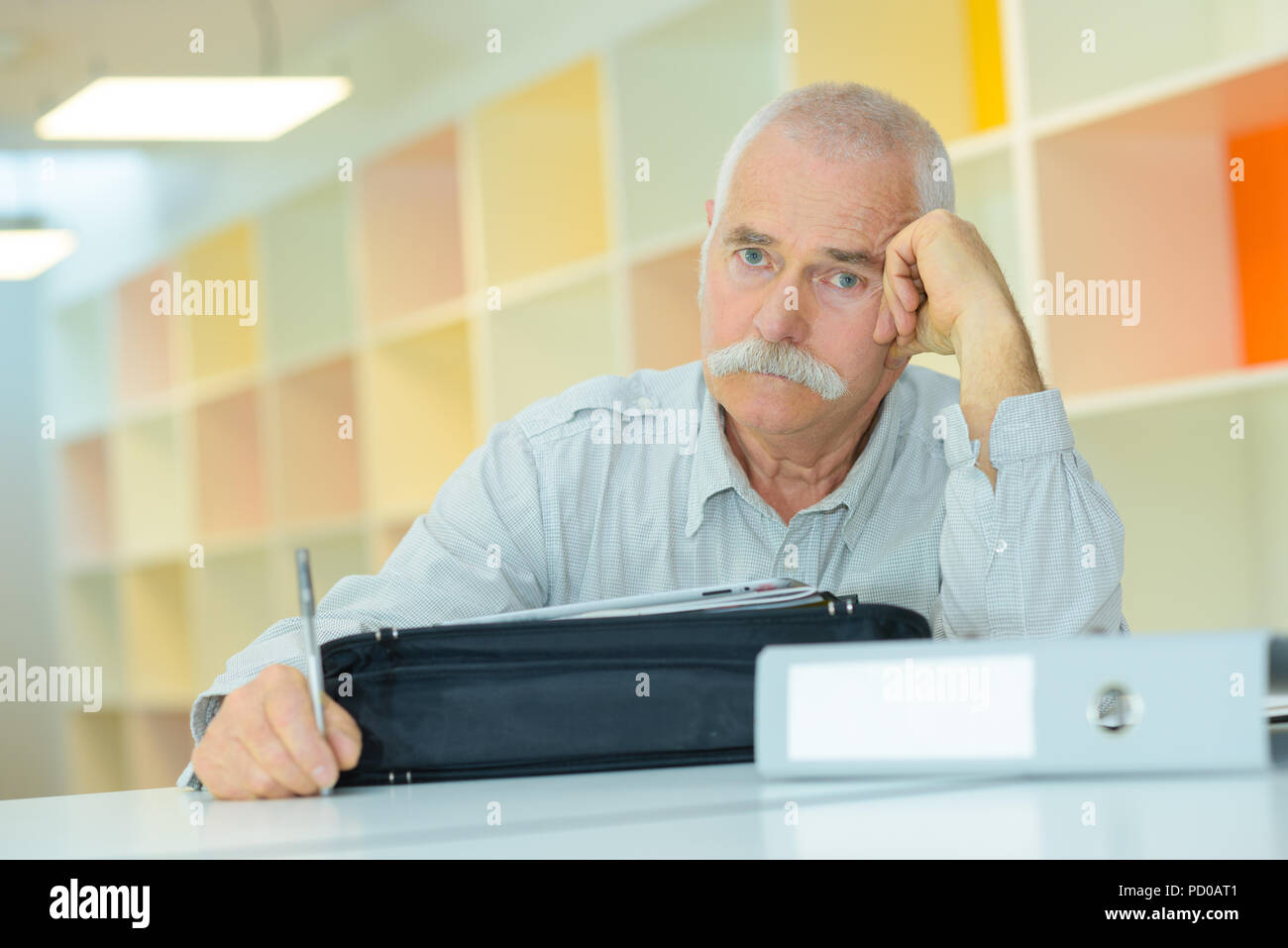tired man waiting to be called Stock Photo - Alamy