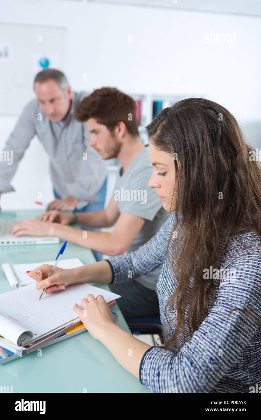 teacher explaining students in the classroom Stock Photo - Alamy