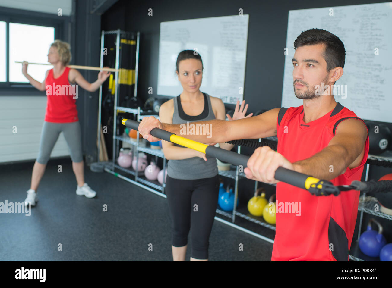 group of people excercising with bars in gym Stock Photo - Alamy