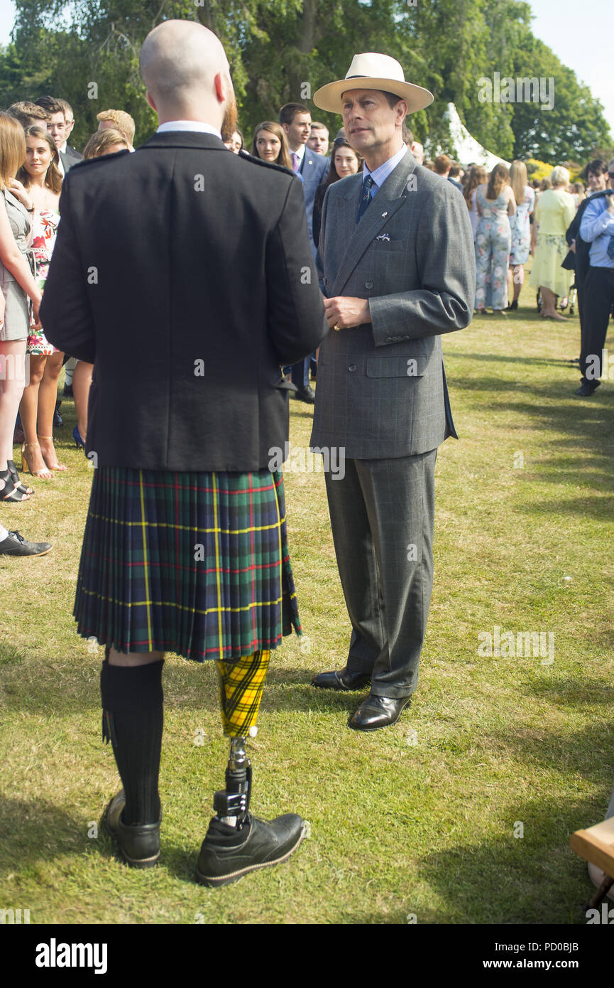 Prince Edward, Earl of Wessex shields himself from the heat under a hat ...