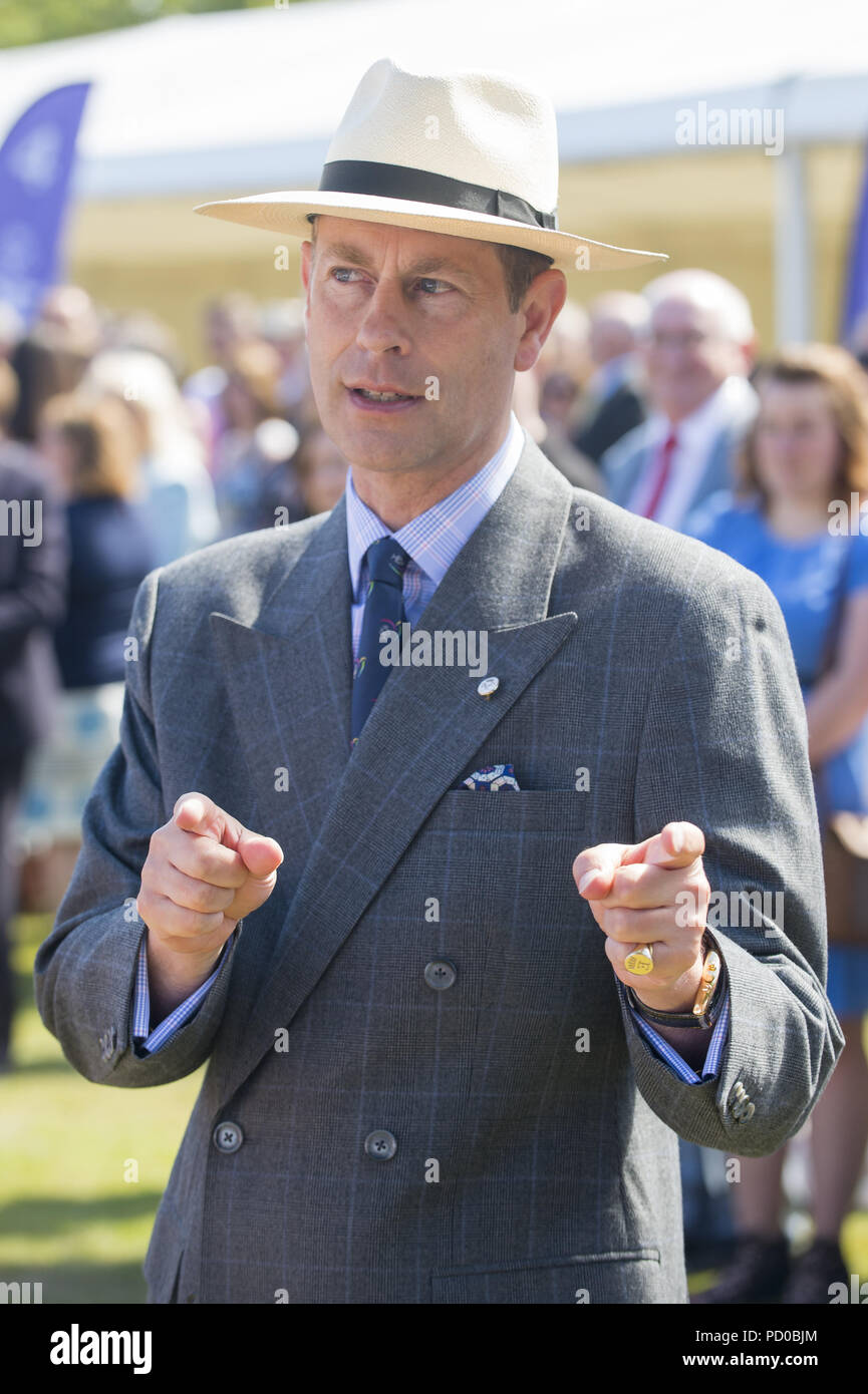 Prince Edward, Earl of Wessex shields himself from the heat under a hat ...