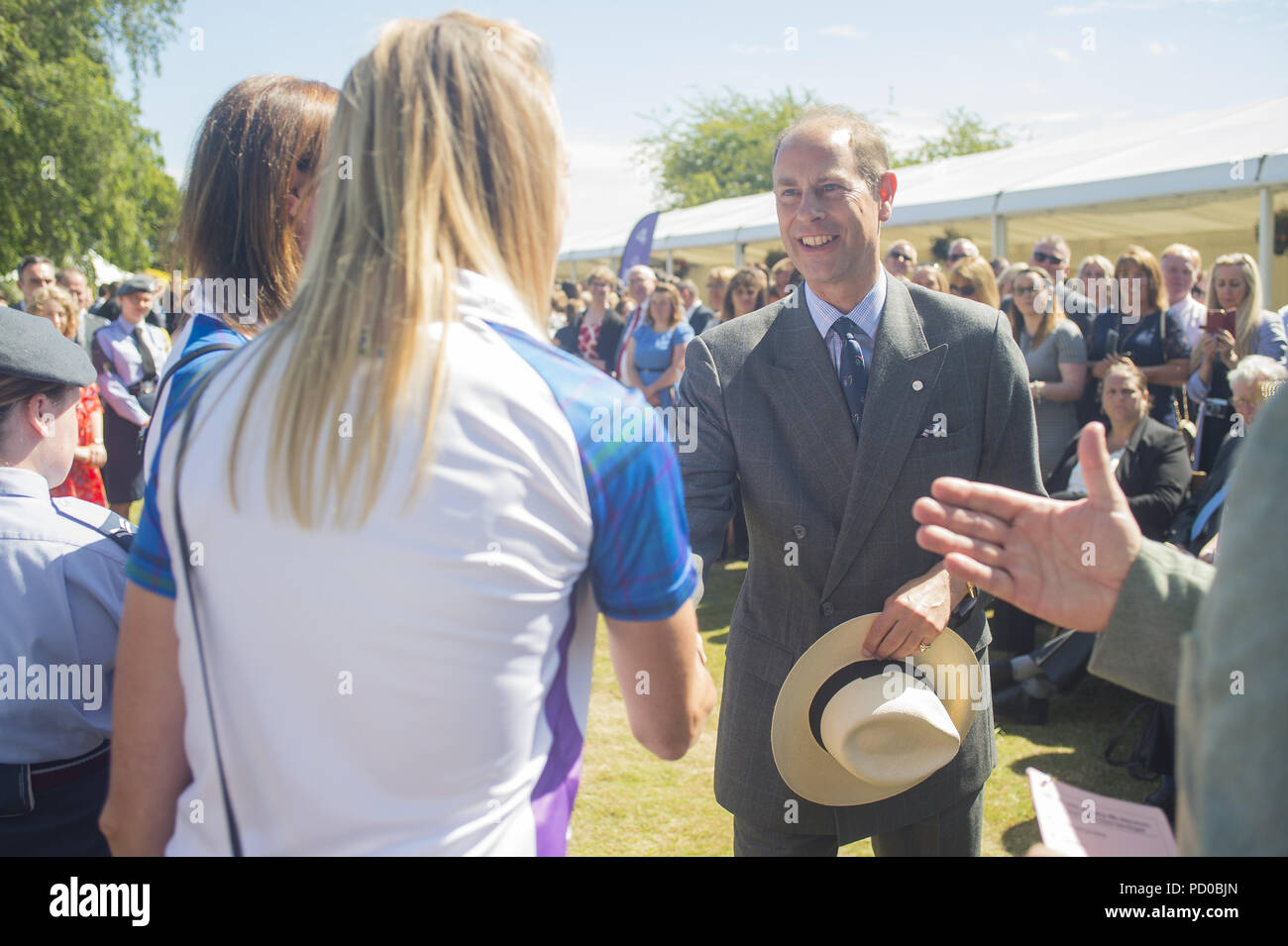 Prince Edward, Earl of Wessex shields himself from the heat under a hat ...
