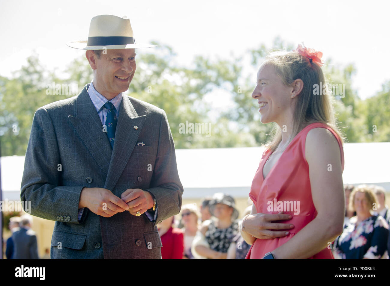 Prince Edward, Earl of Wessex shields himself from the heat under a hat ...