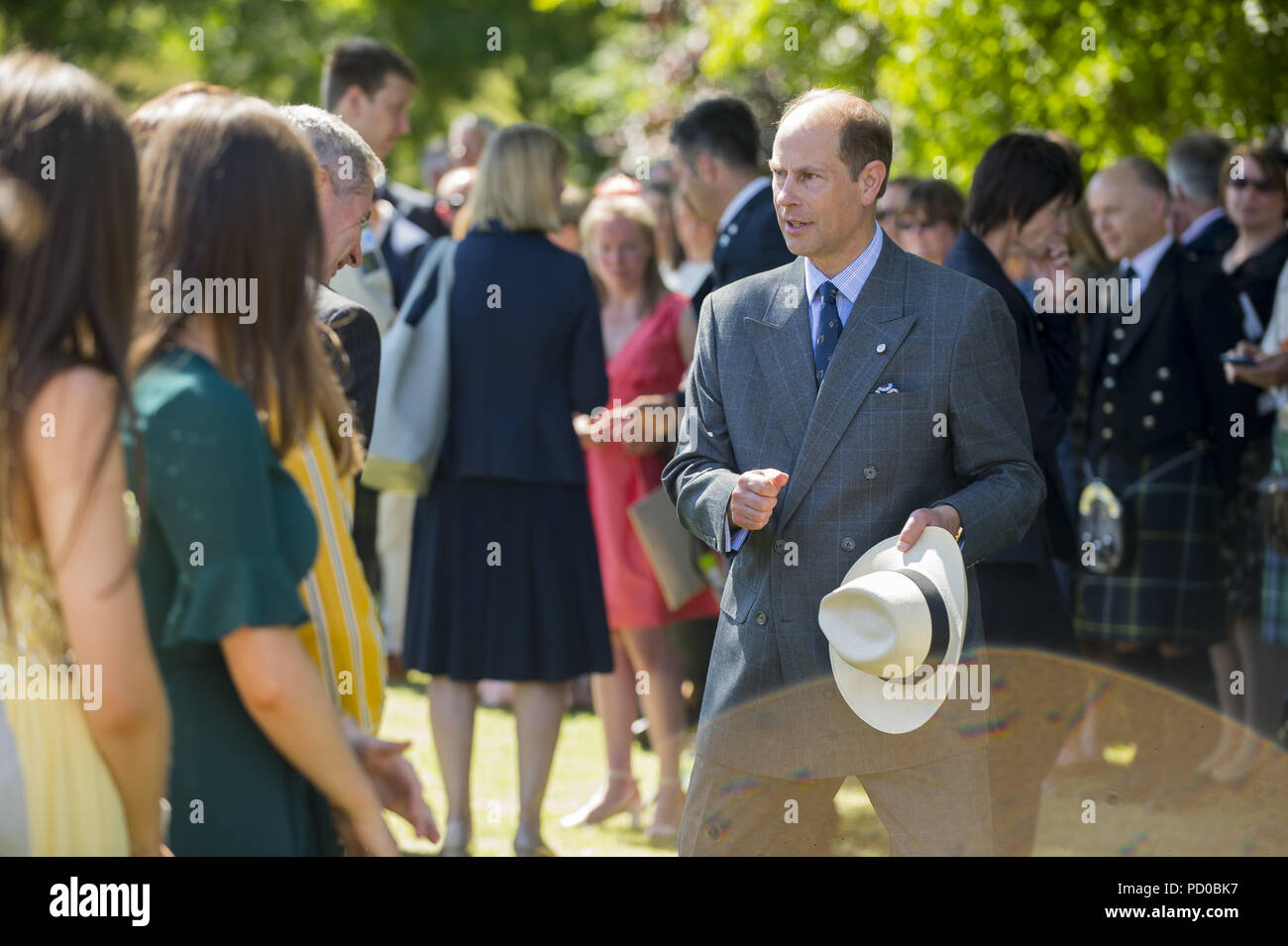Prince Edward, Earl of Wessex shields himself from the heat under a hat ...